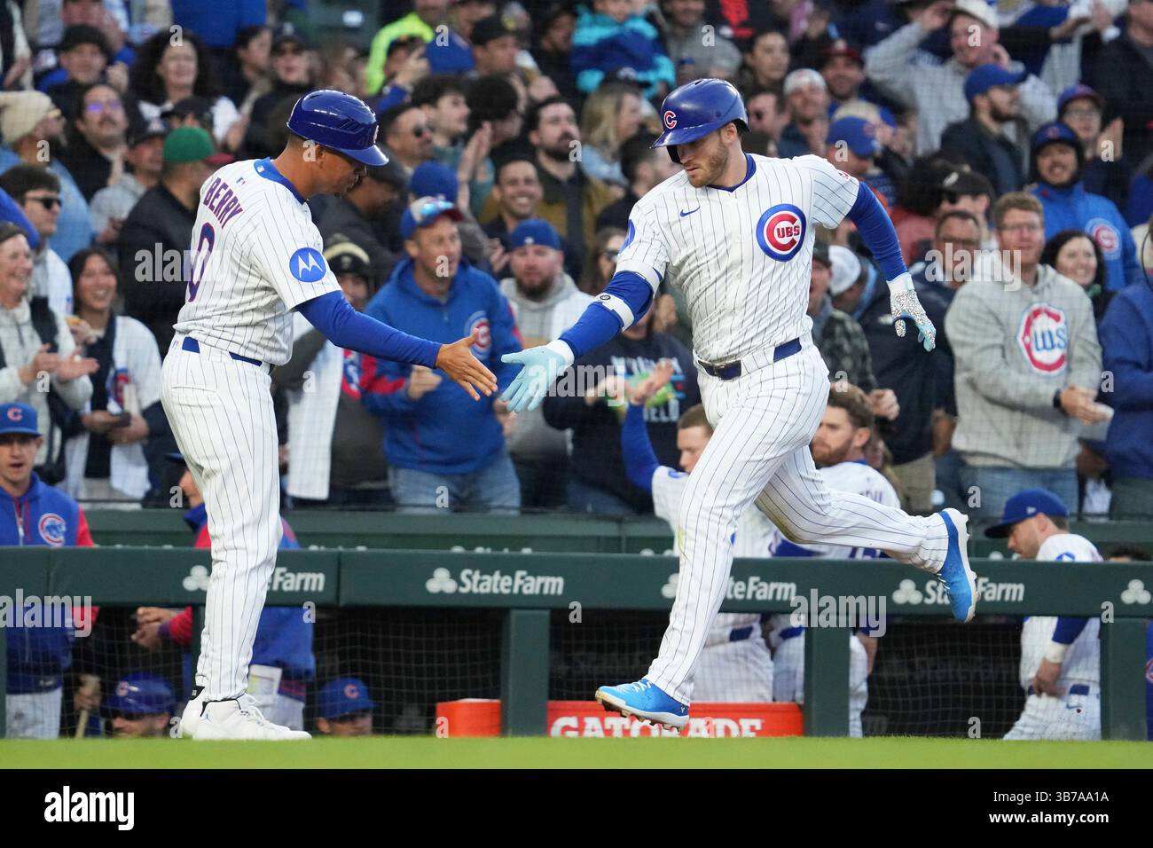 Chicago Cubs' Ian Happ, right, rounds the bases as he celebrates with ...