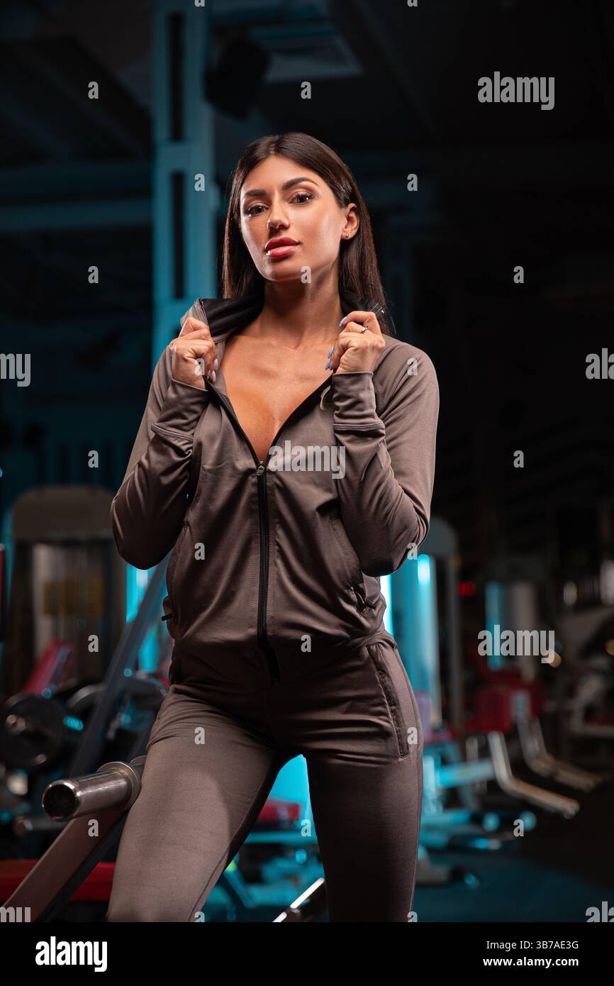 fitness enthusiast poses confidently in contemporary gym wearing ...