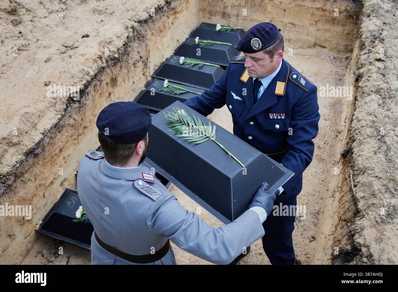 German soldiers carry the small coffins with the remains of fallen ...