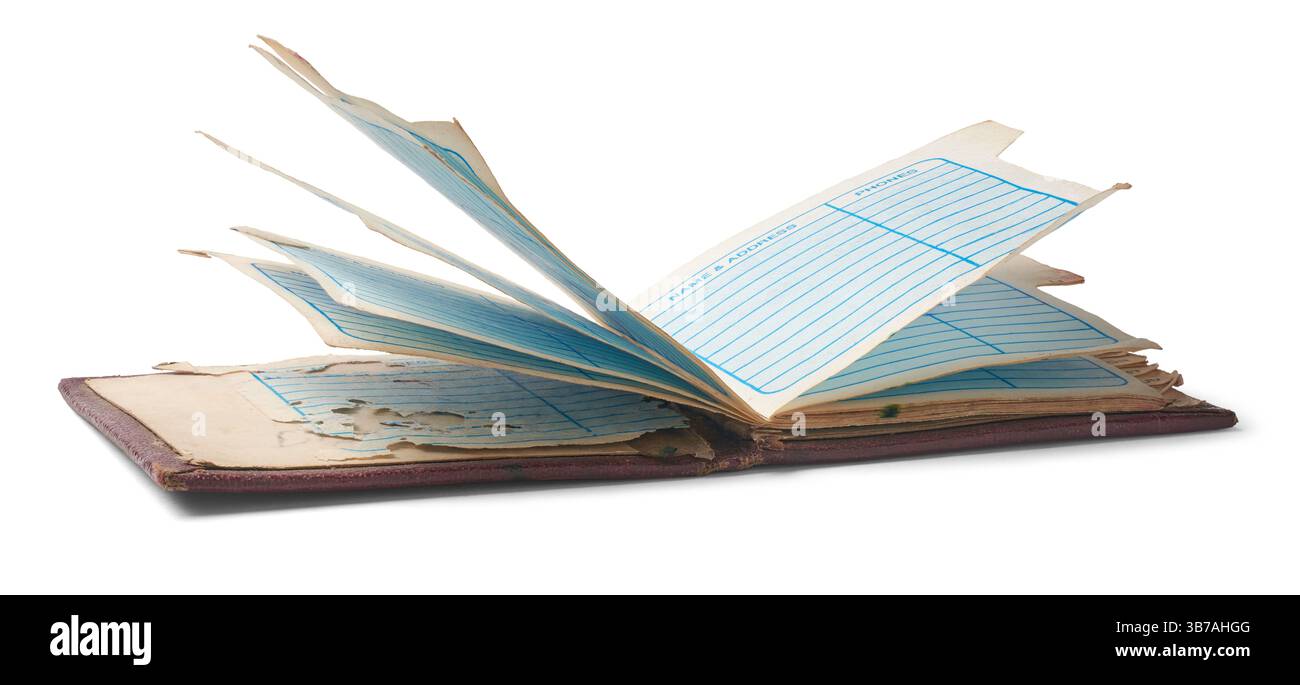 close-up of old worn out phone book lying open isolated white ...