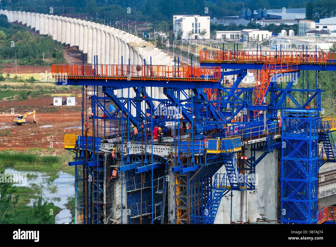 Construction workers are building bridge piers along the Railway line ...