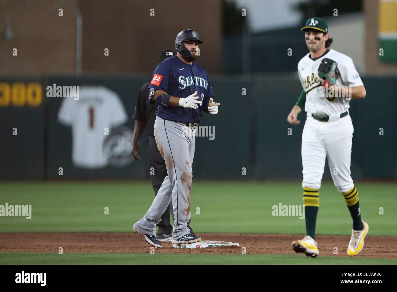 Seattle Mariners' Rowdy Tellez, front left, gestures toward his dugout ...