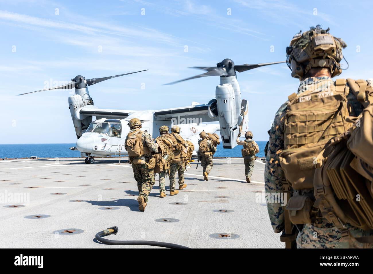U.S. Marines with Golf Company, 2nd Battalion, 2nd Marine Regiment, board an MV-22 Osprey ...