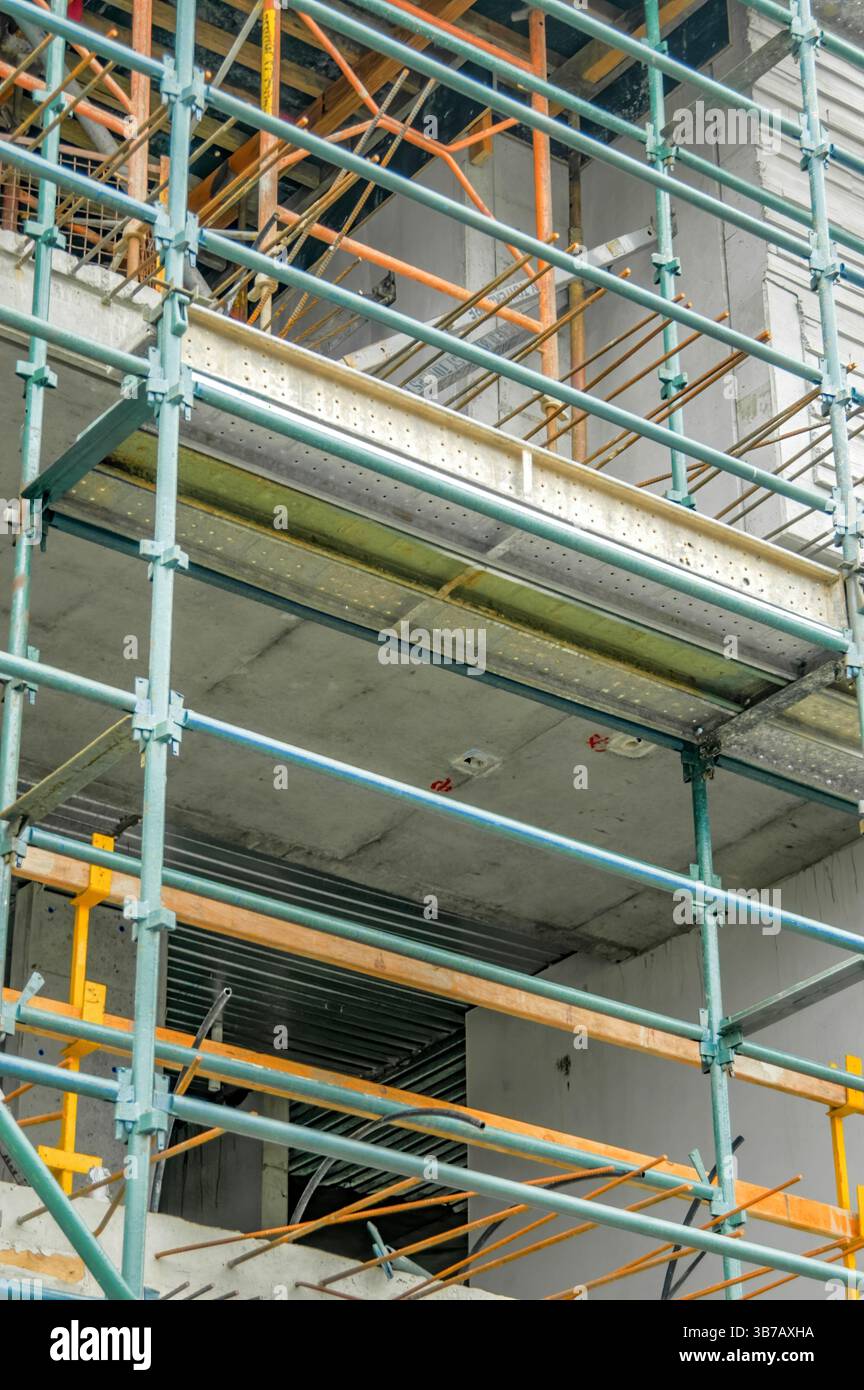 Scaffolding framework surrounding a building under construction, with ...