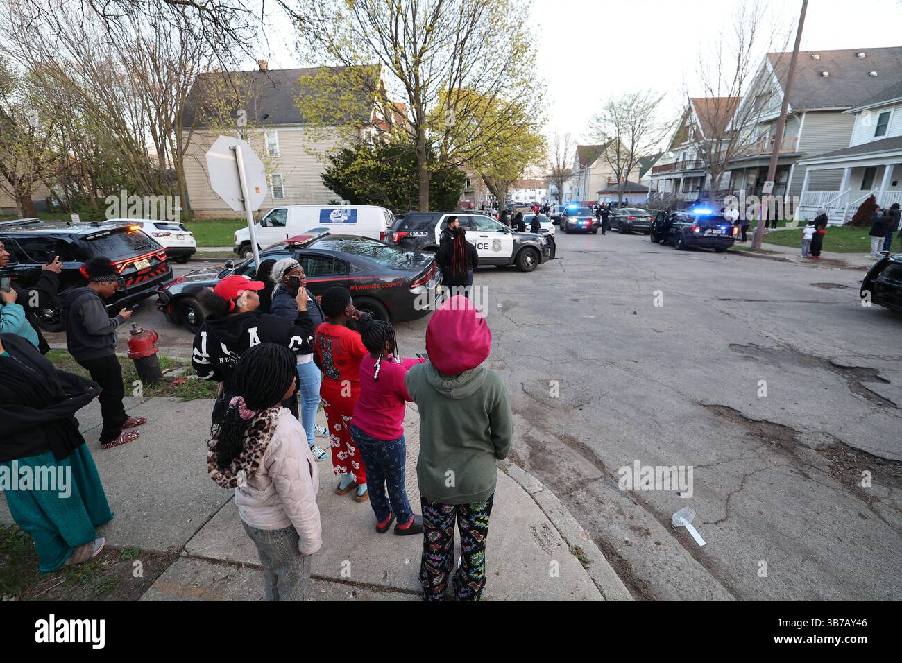 May 5, 2025, Milwaukee, Wisconsin, USA: Neighbors watch police activity ...