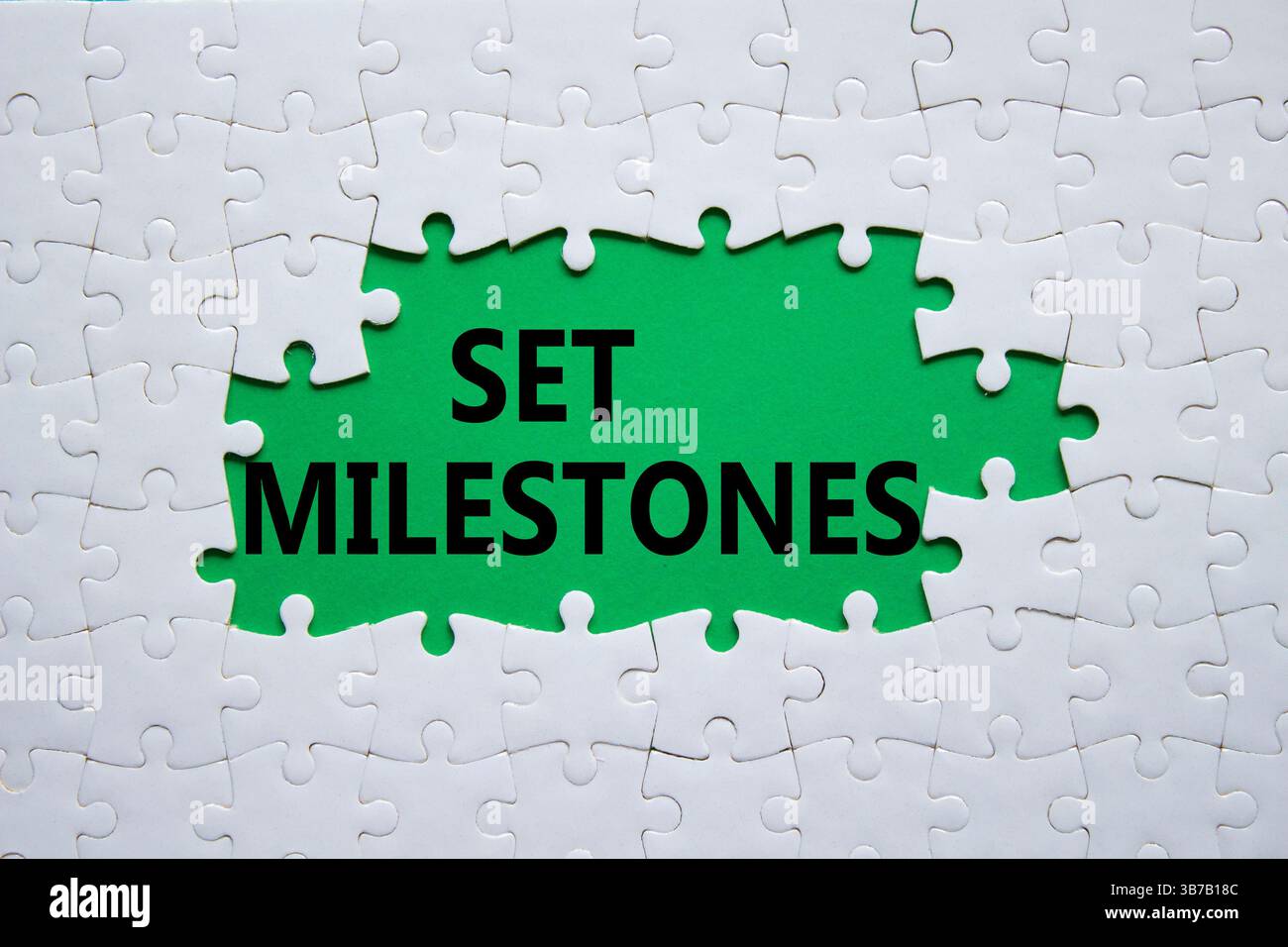Set milestones symbol. Concept word Set milestones on white puzzle ...