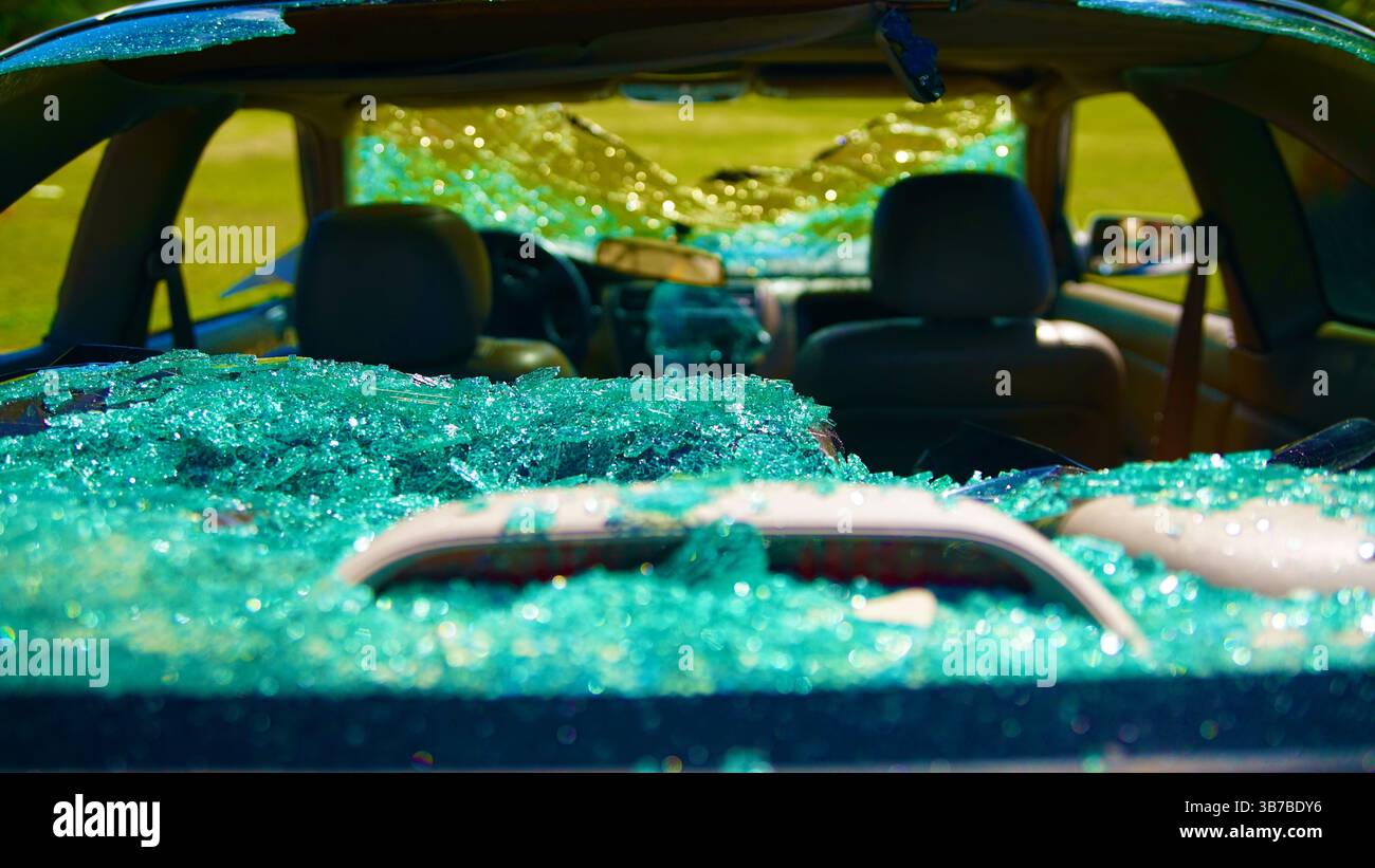 Shattered car windows and scattered glass show the aftermath of a crash ...