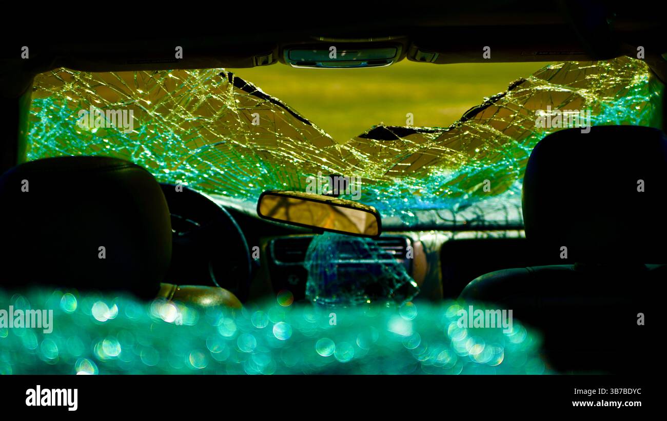 Shattered car windows and scattered glass show the aftermath of a crash ...
