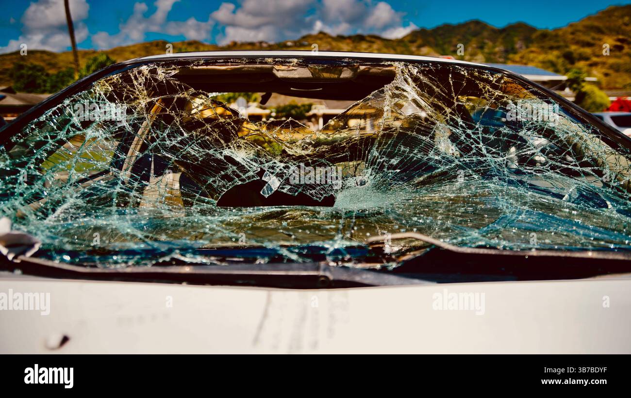 Shattered car windows and scattered glass show the aftermath of a crash ...