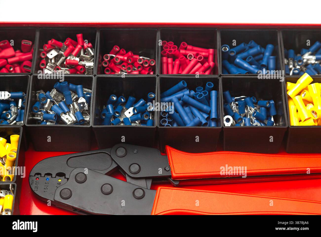 A box of new terminals for electrical wires of different colors and a ...