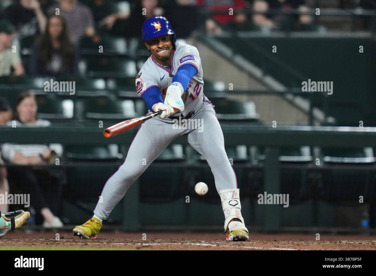New York Mets' Francisco Lindor reaches out to hit an infield grounder ...