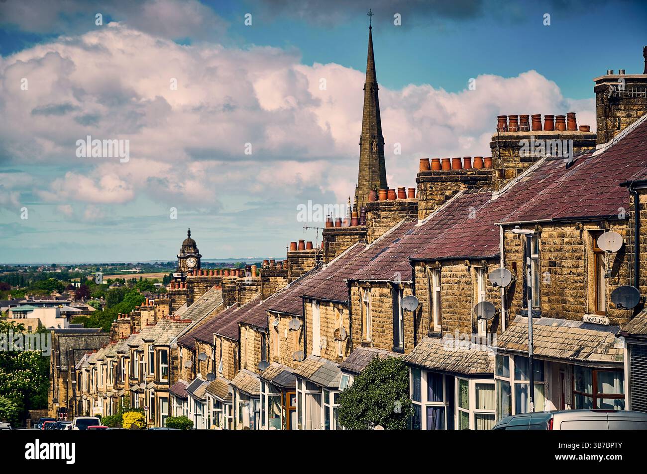 Spire of Lancaster cathedral over roofs of terrace houses in lancaster ...
