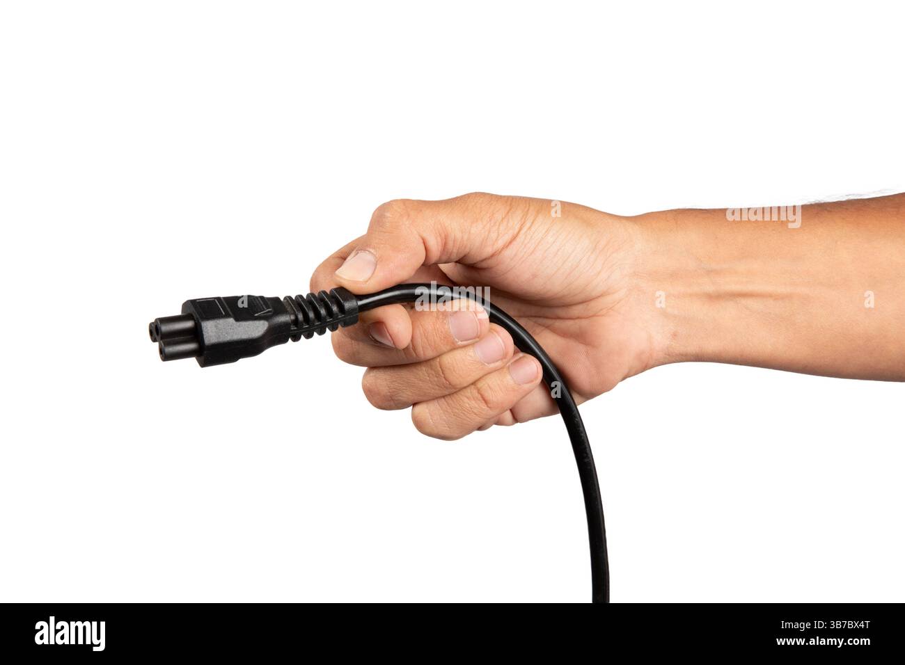 Male hand holding a black computer power cable isolated on white ...