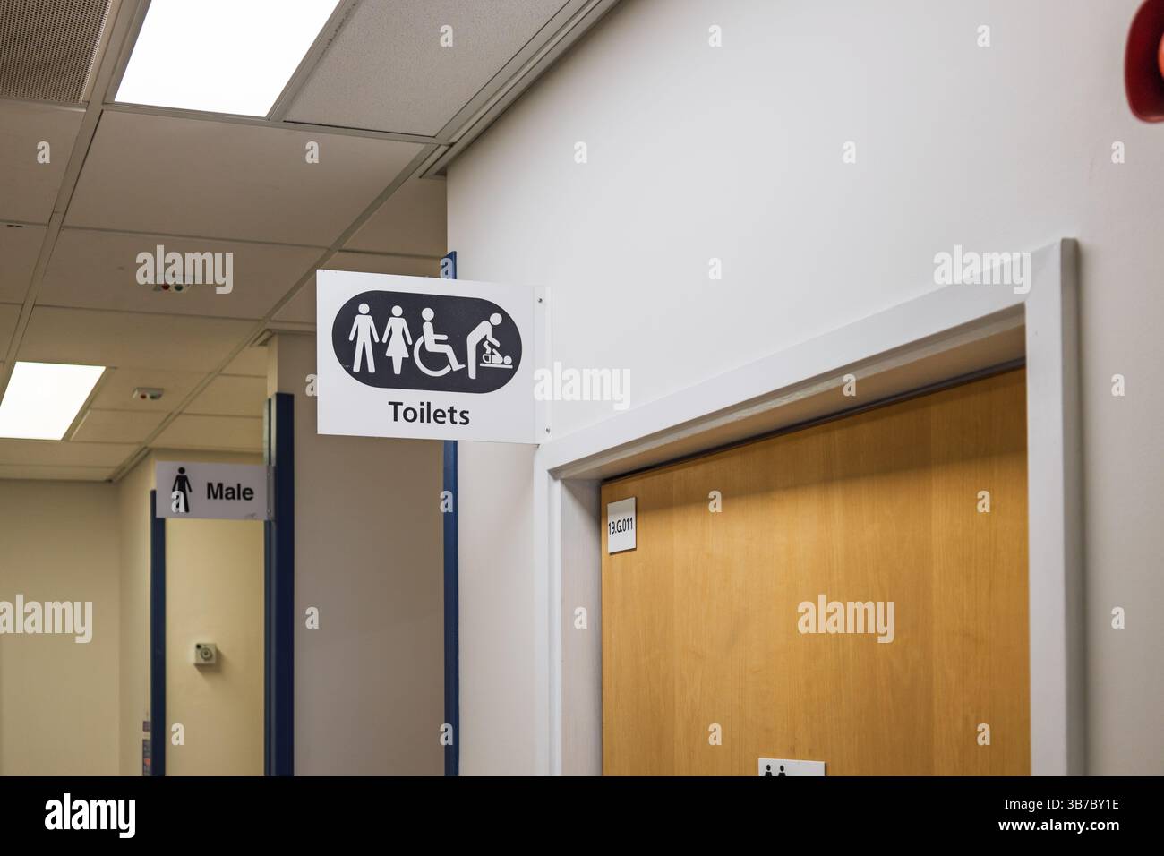 Restroom sign above door in clean hallway of public building Stock ...