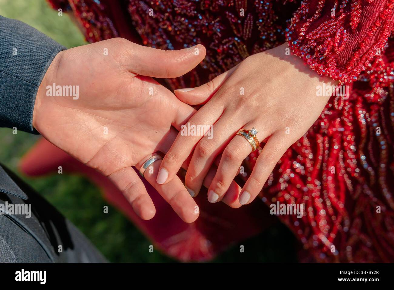 Two hands depicted joining in a romantic engagement moment. A couple ...