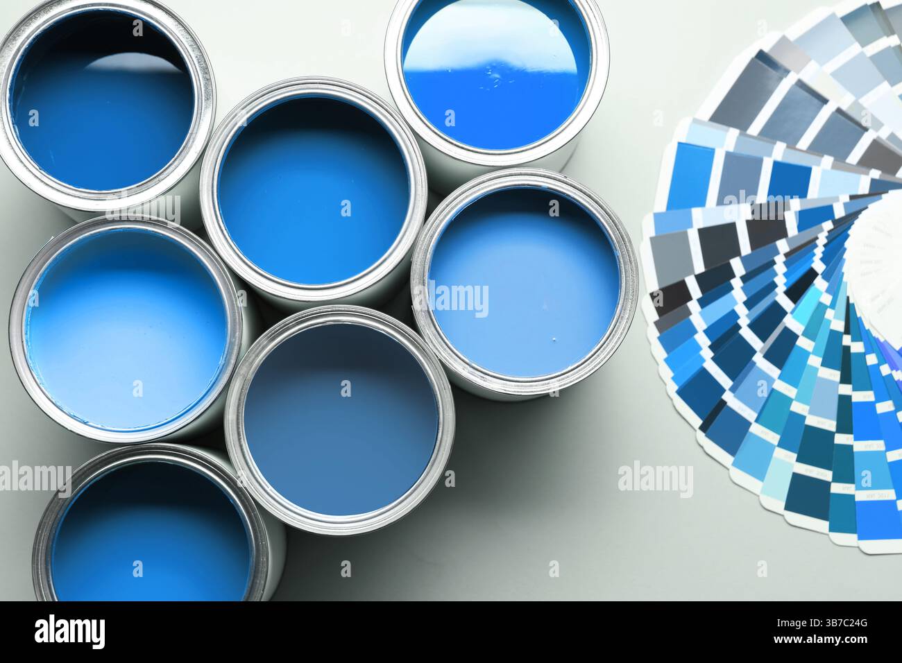 Cans with paint in shades of blue and color palette on white background ...