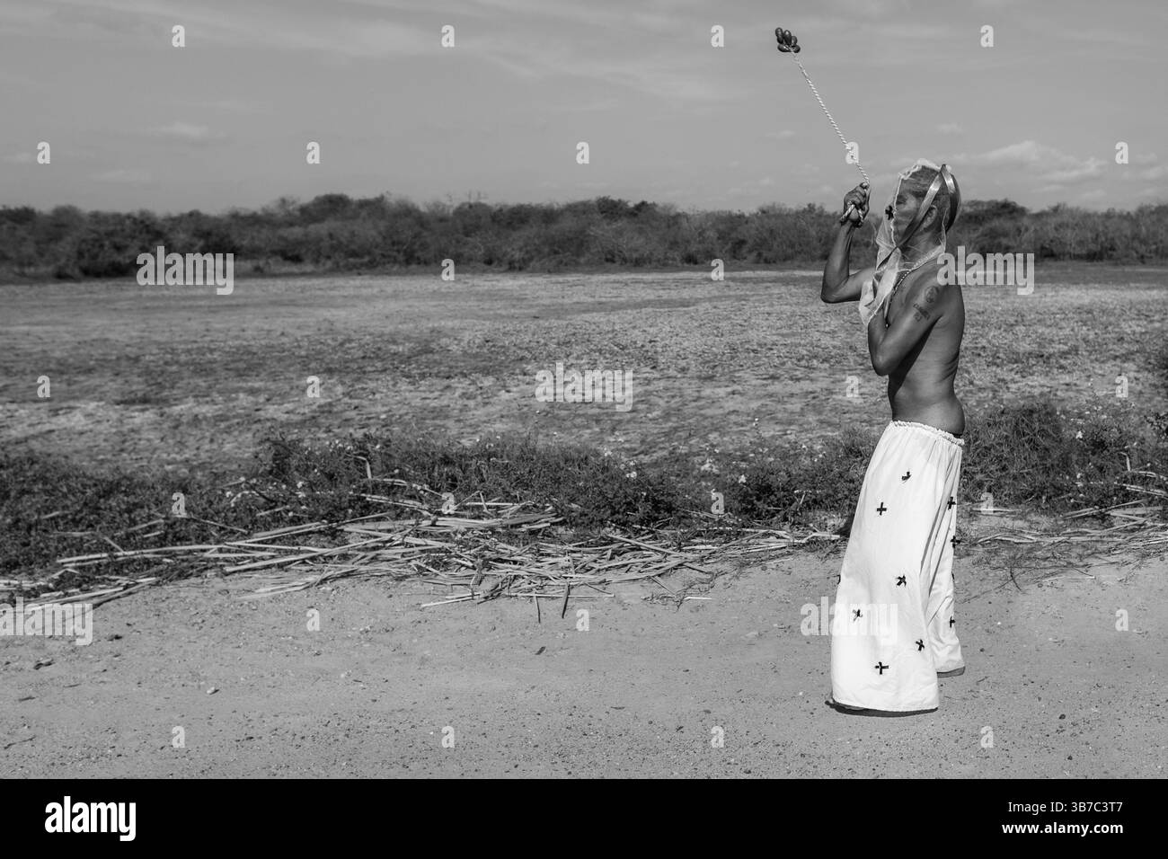 An Afro-Colombian man walks while whipping himself as part of a penance ...