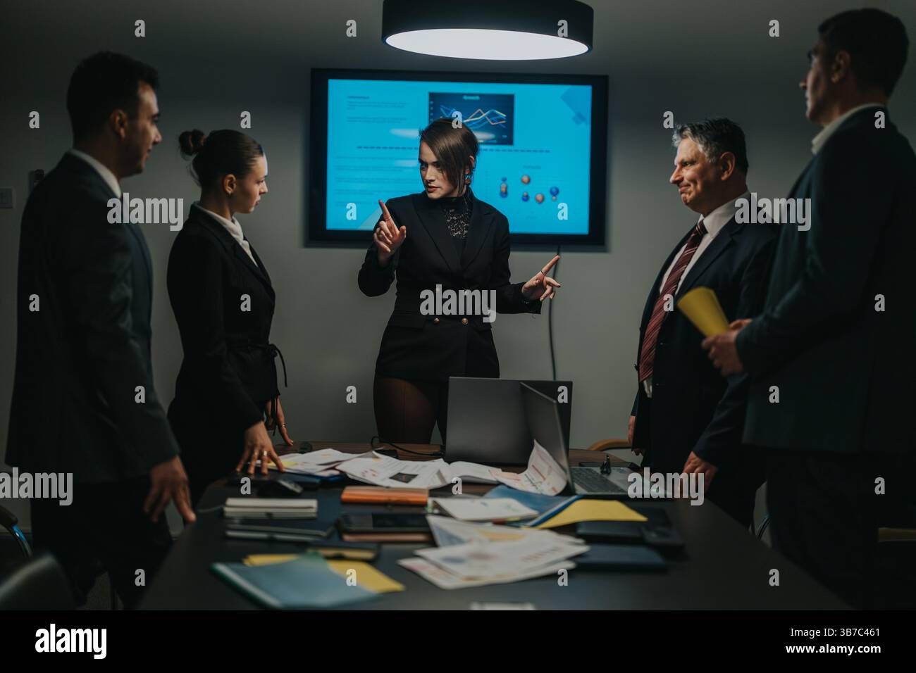 Business meeting discussion with professionals in formal attire around ...