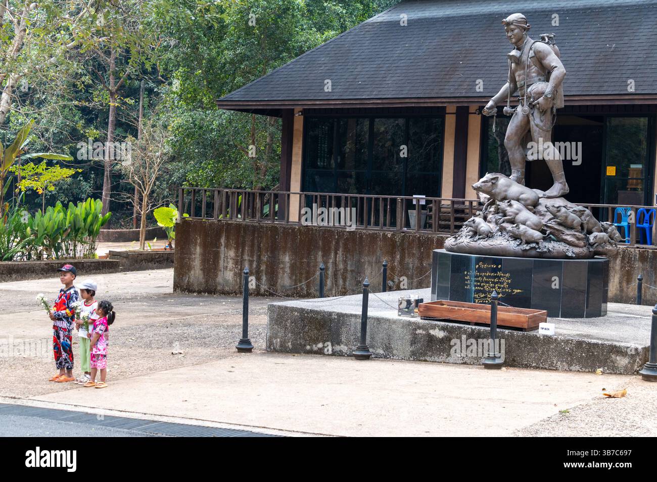 A group of children in front of a bronze statue of Saman Gunan, a diver ...