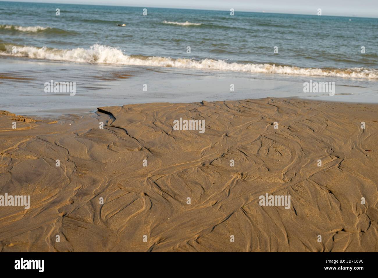 Patterns in sand at low tide on beach created by receding tide Stock ...