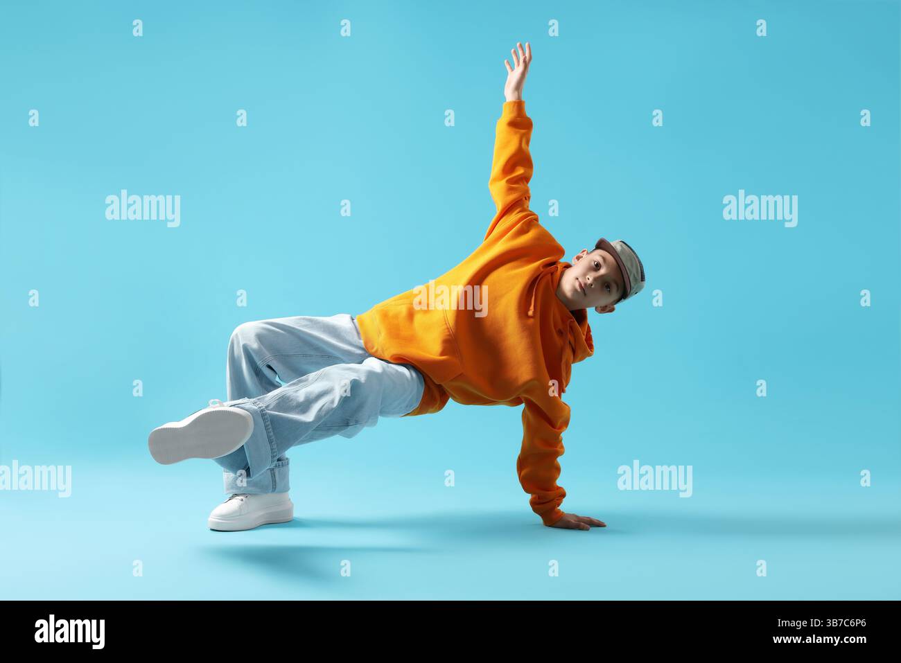 Boy in stylish clothes dancing on light blue background Stock Photo - Alamy