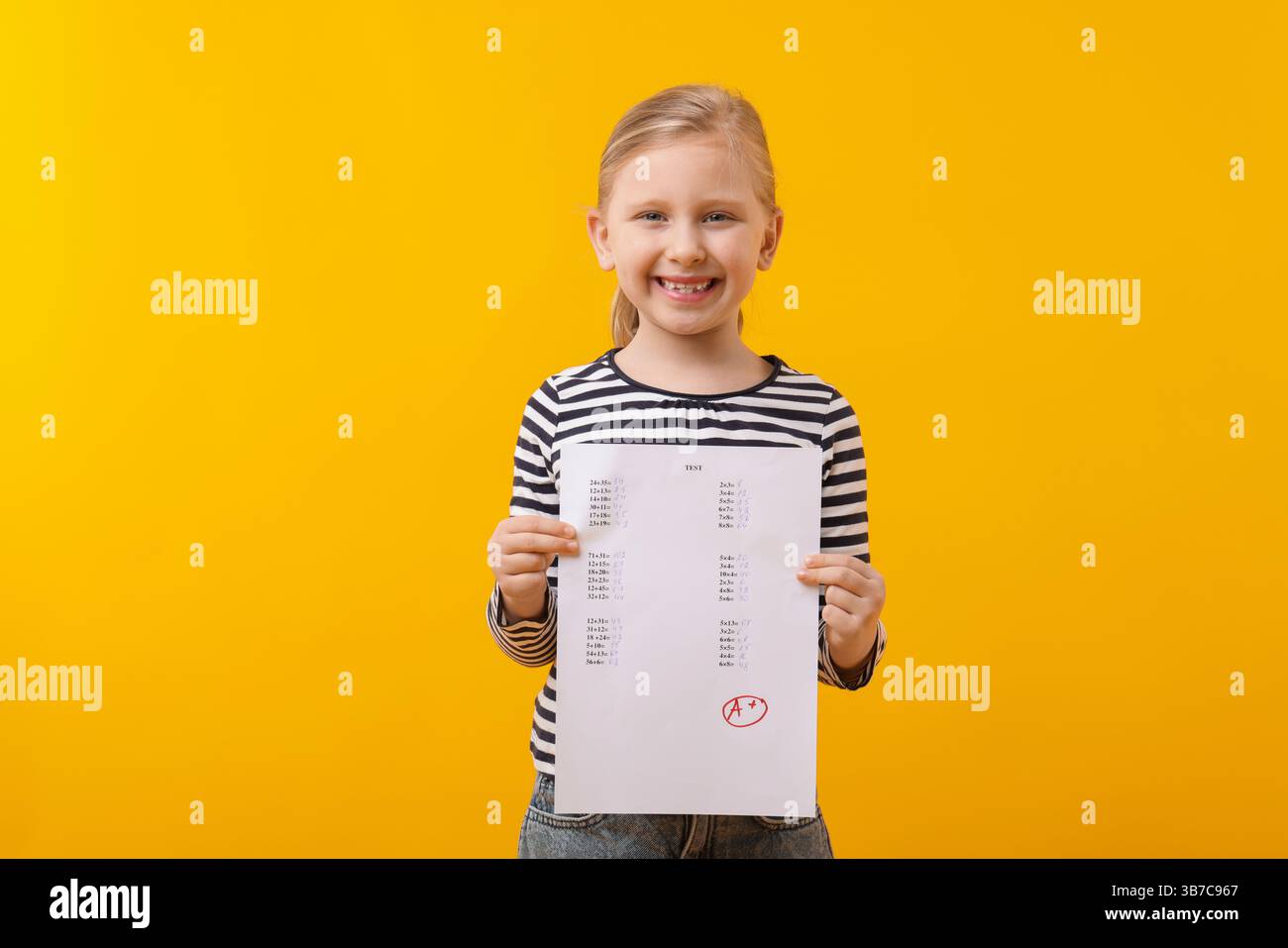 School grade. Little girl holding answer sheet with letter A and plus ...