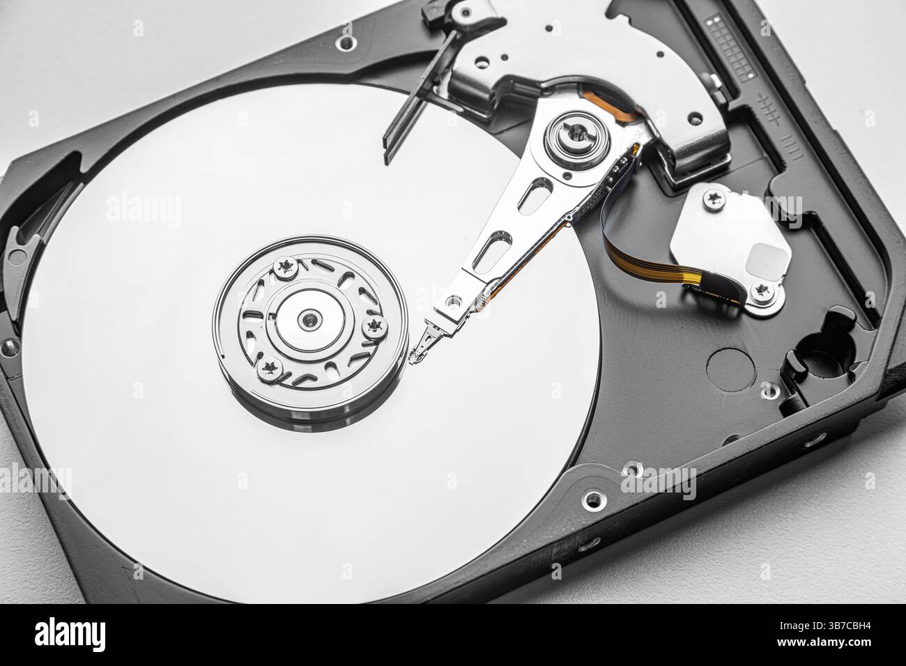 Open hard disk drive reveals its shiny platter Stock Photo - Alamy
