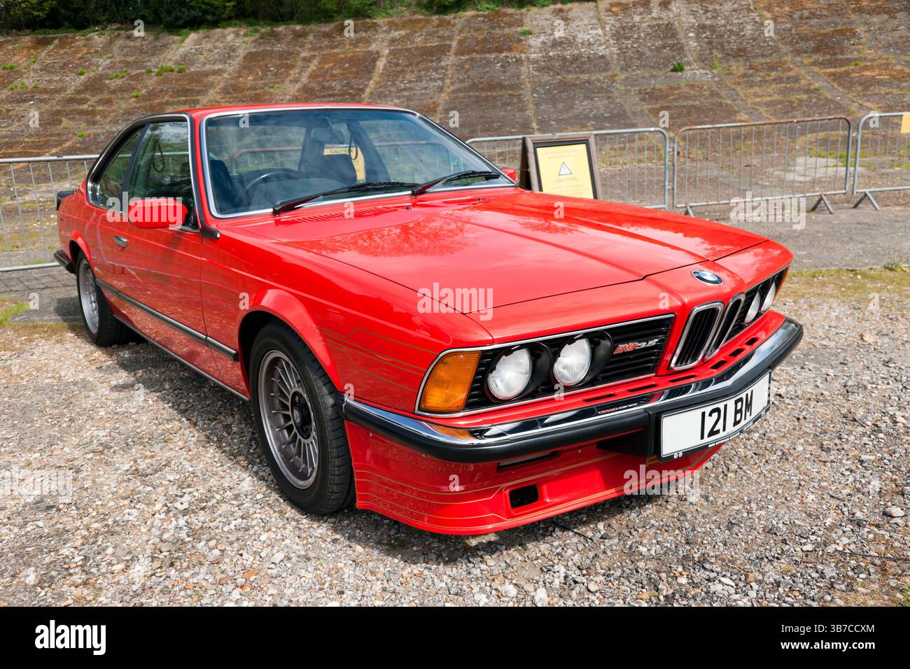 Three-quarters front view of a Red, 1984, BMW B9 Alpina, on display by ...