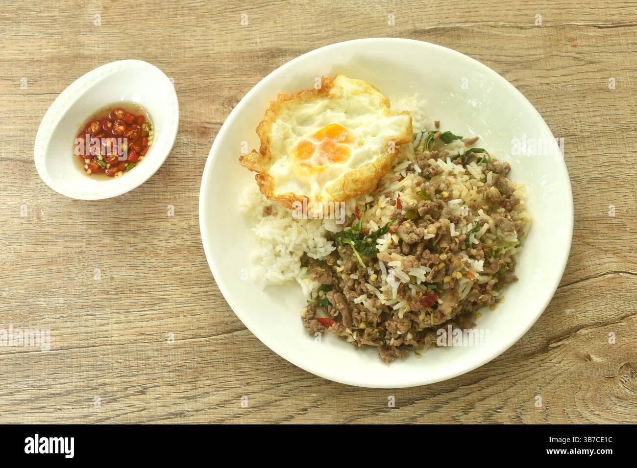 spicy stir fried chop beef meat with basil leaf and chili on rice ...