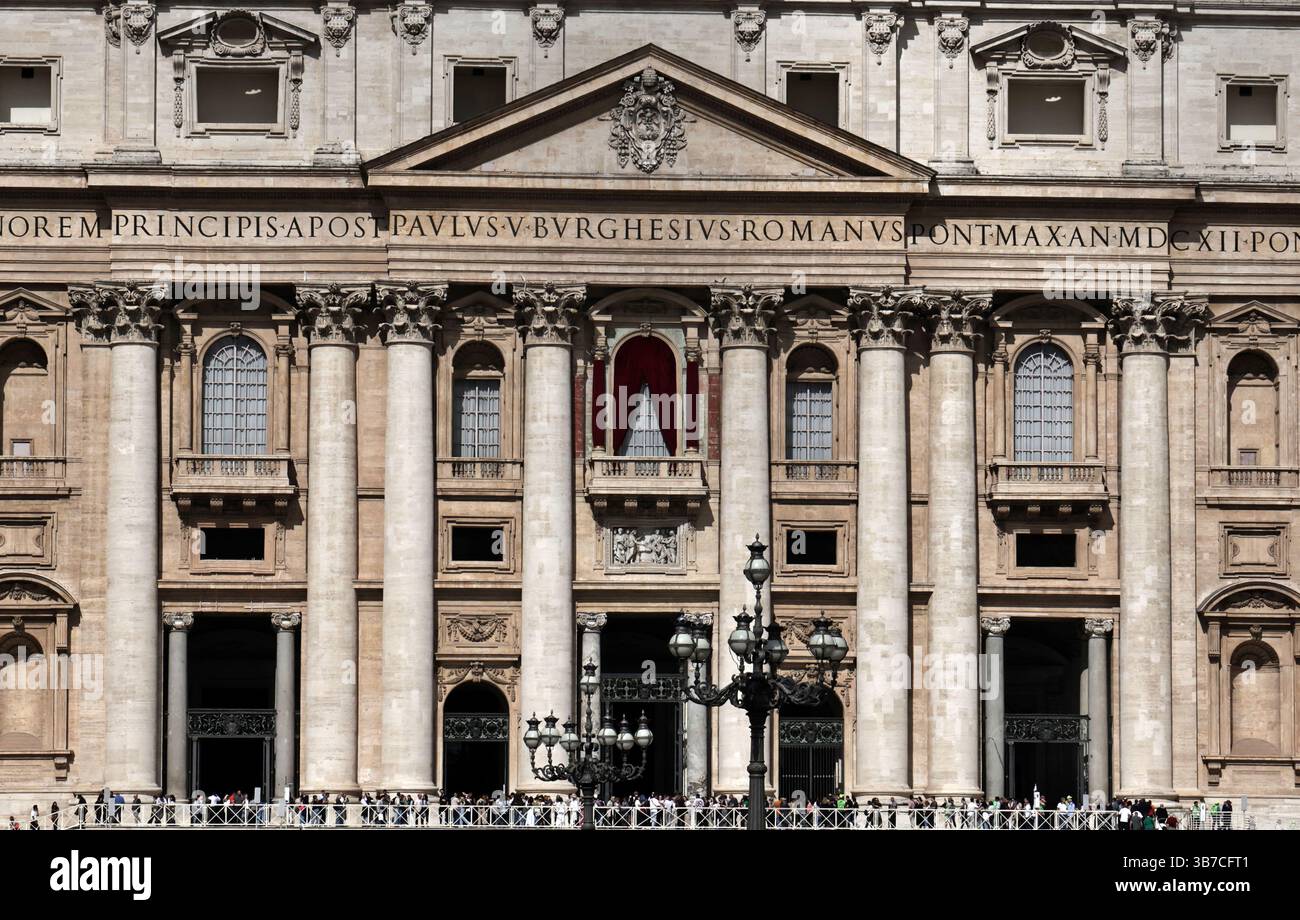 May 6, 2025 - Vatican City. Red drapes are wrapped around columns of ...