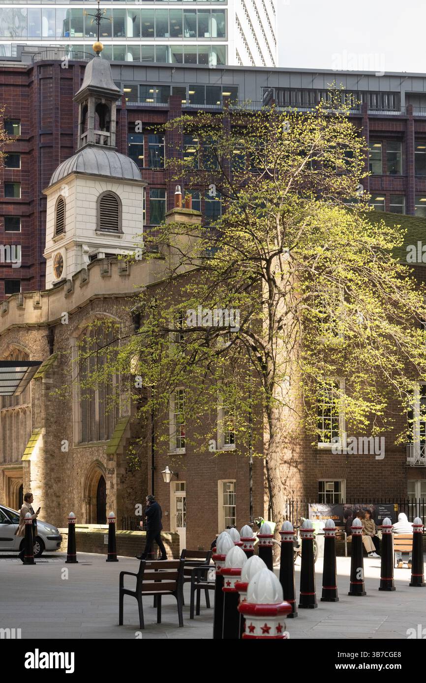 People stroll and relax outside St Helen's Church, Bishopsgate in City ...