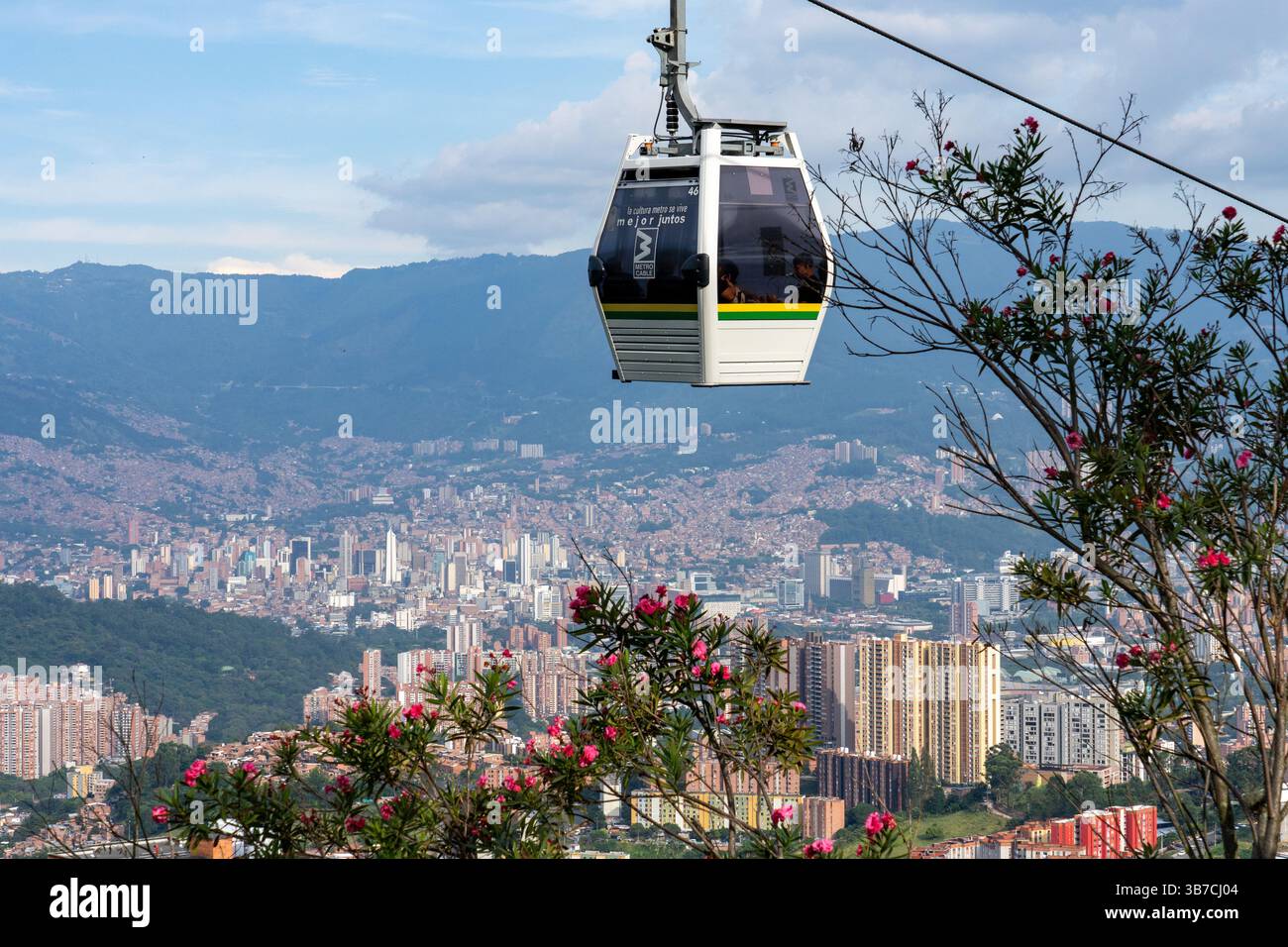 A gondola of the Medellin Metrocable system with downtown Medellin ...