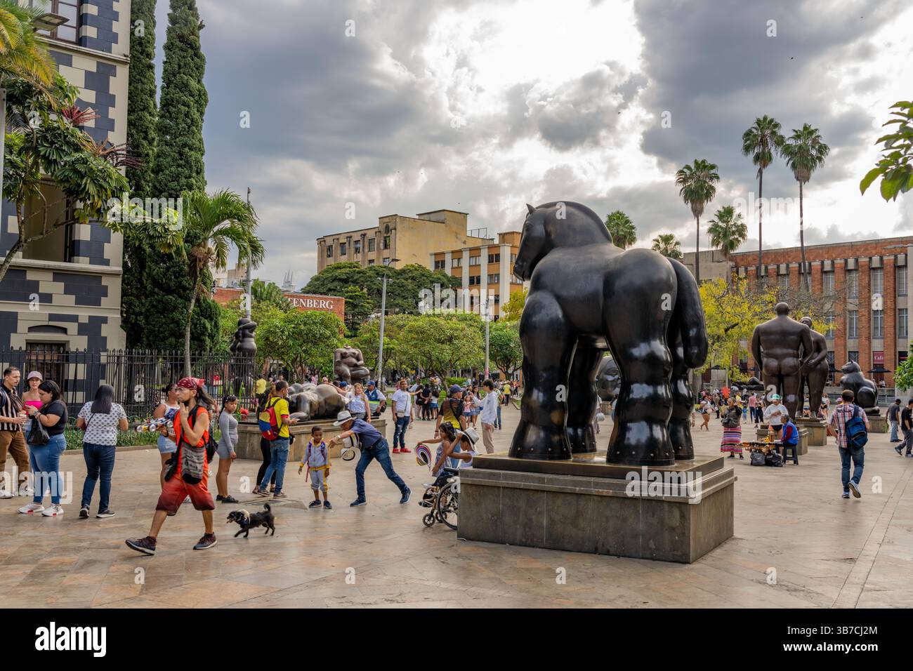 People walking by sculptures by Fernando Botero in the Botero Plaza in ...