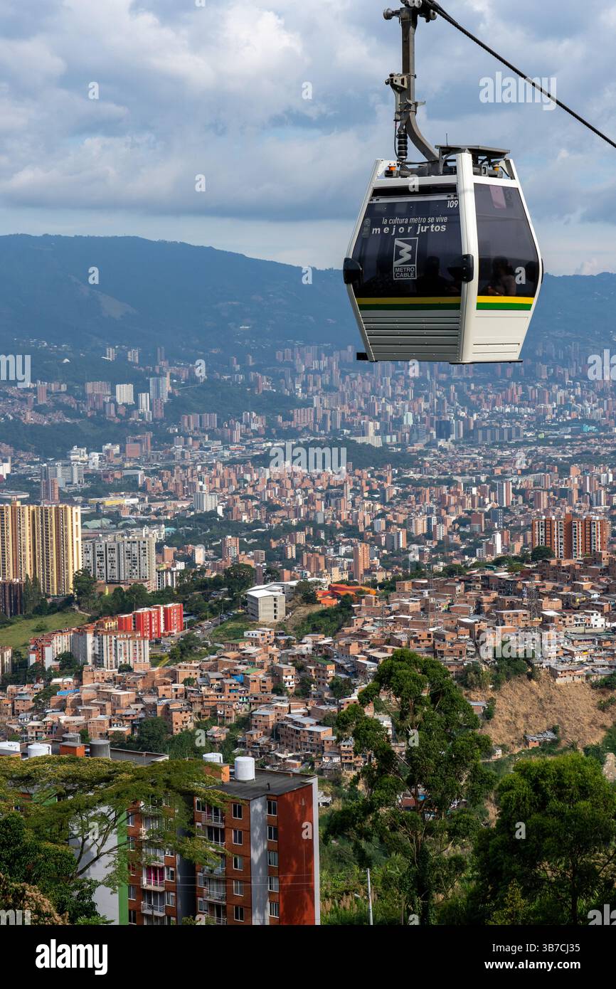 A gondola of the Medellin Metrocable system with downtown Medellin ...