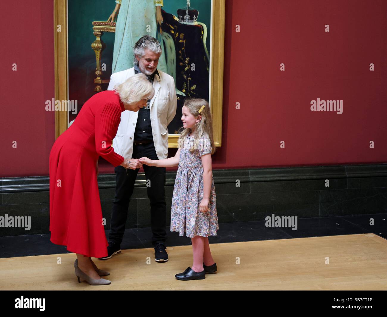 Queen Camilla (centre) meets with Paul S. Benney and his daughter ...