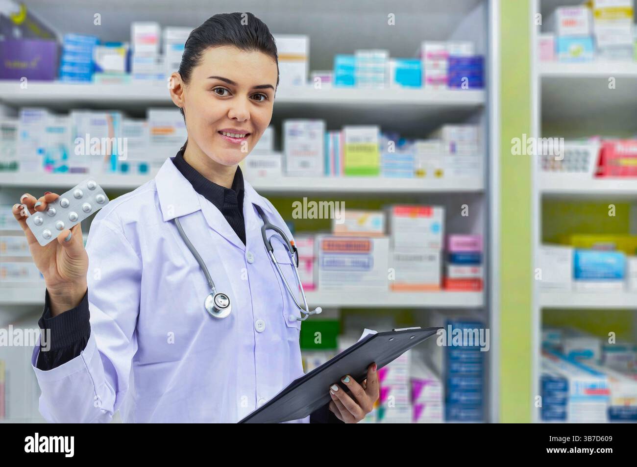 Beautiful young pharmacist holding medicine capsule and prescription ...