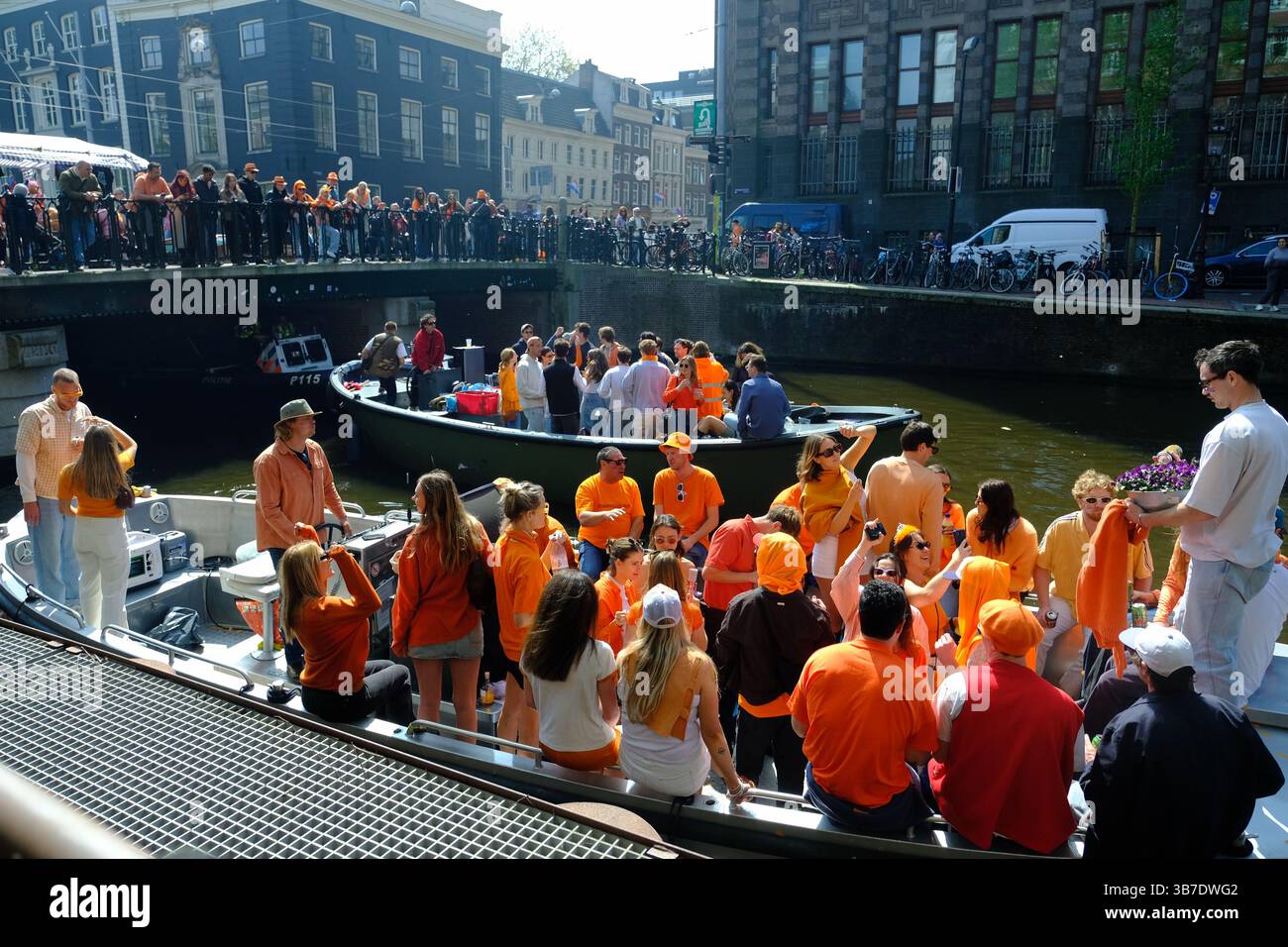 Revellers ride boats as they cruise down a canal on King's Day on April ...