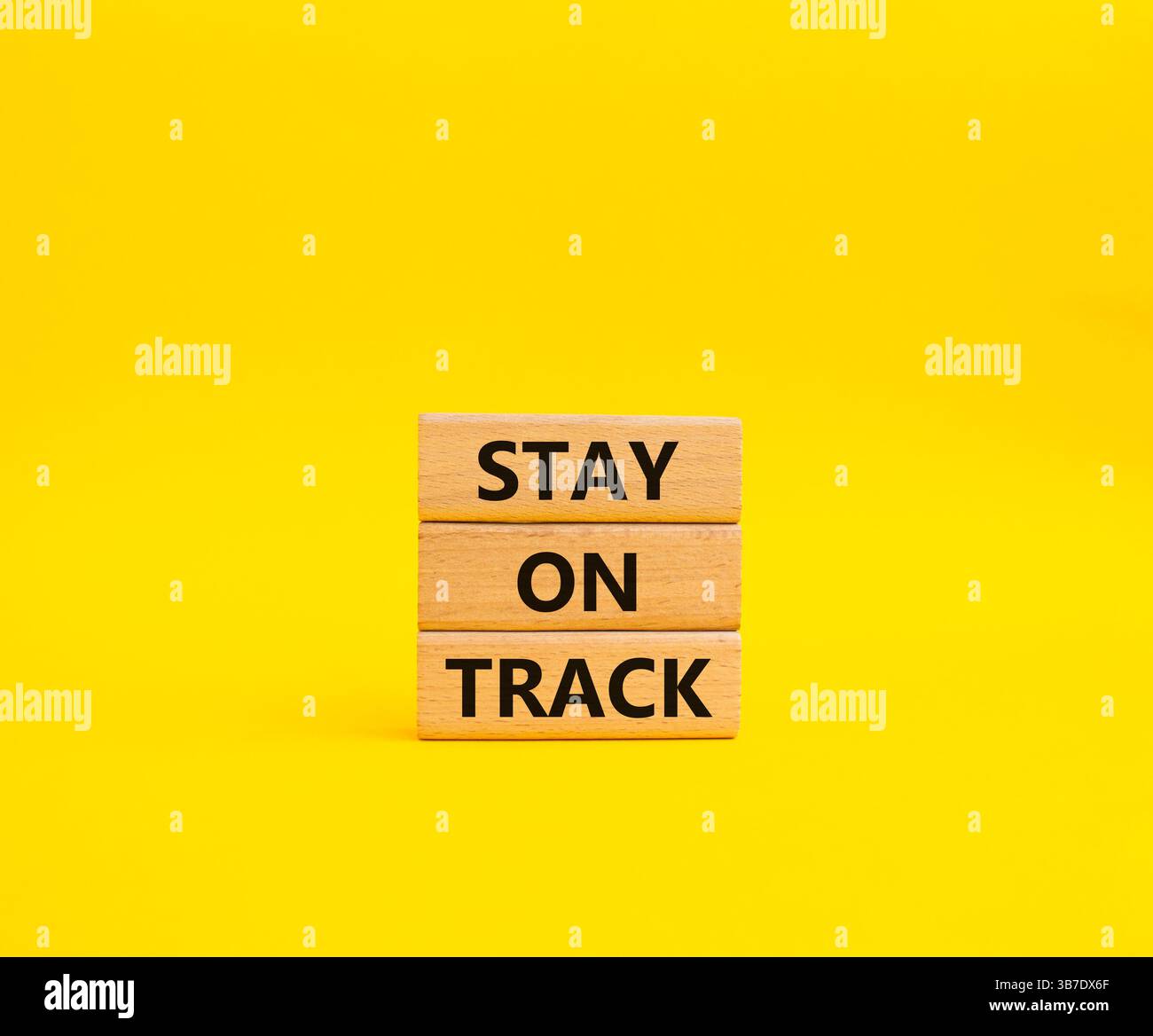 Stay on track symbol. Wooden blocks with words 'Stay on track ...