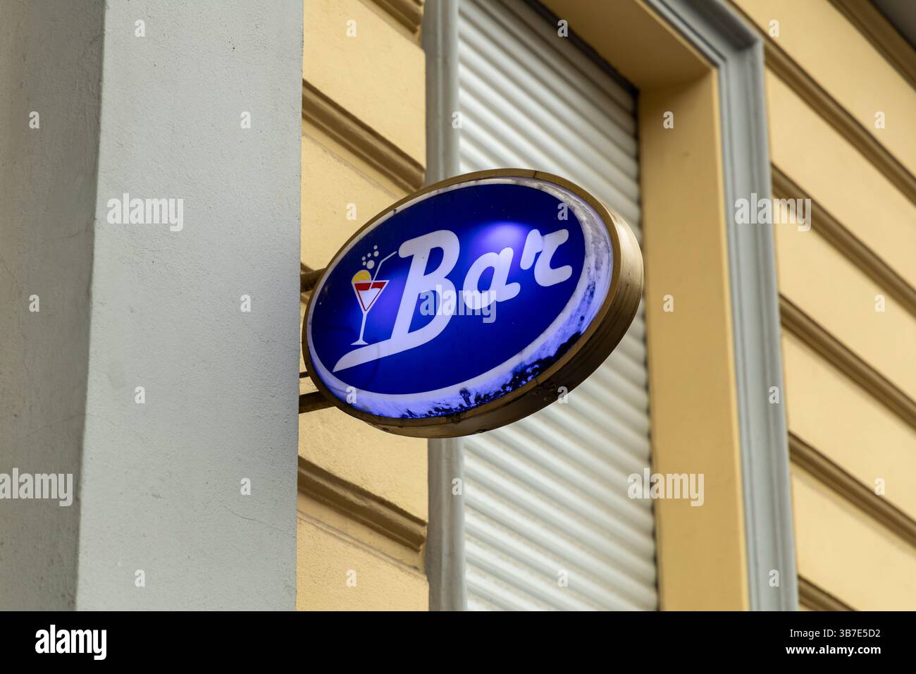 Vintage-style illuminated bar sign mounted on a building wall in Berlin ...