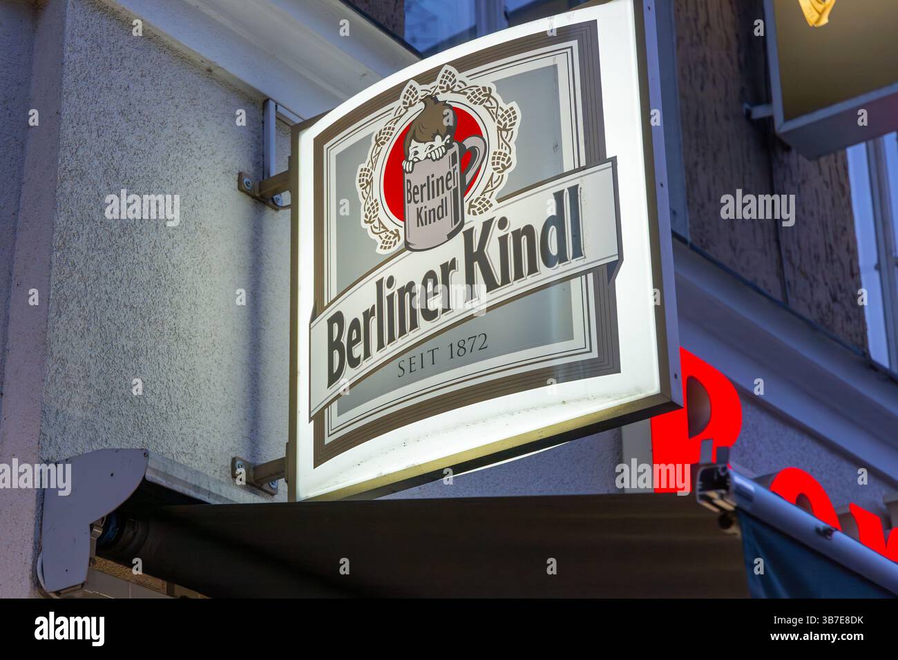 Illuminated Berliner Kindl beer sign on a building facade in Berlin ...