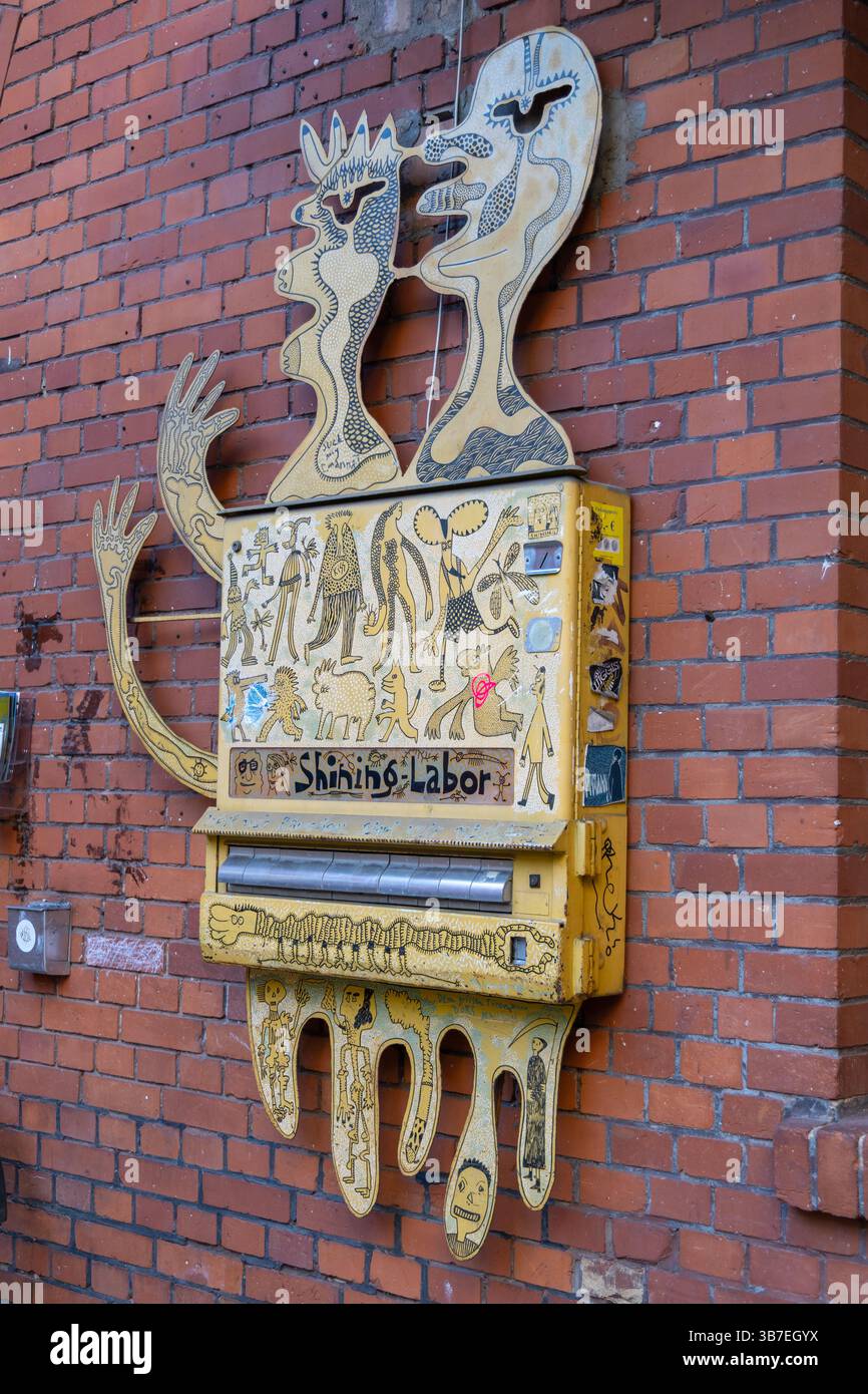Colorful urban art installation on a brick wall featuring abstract ...