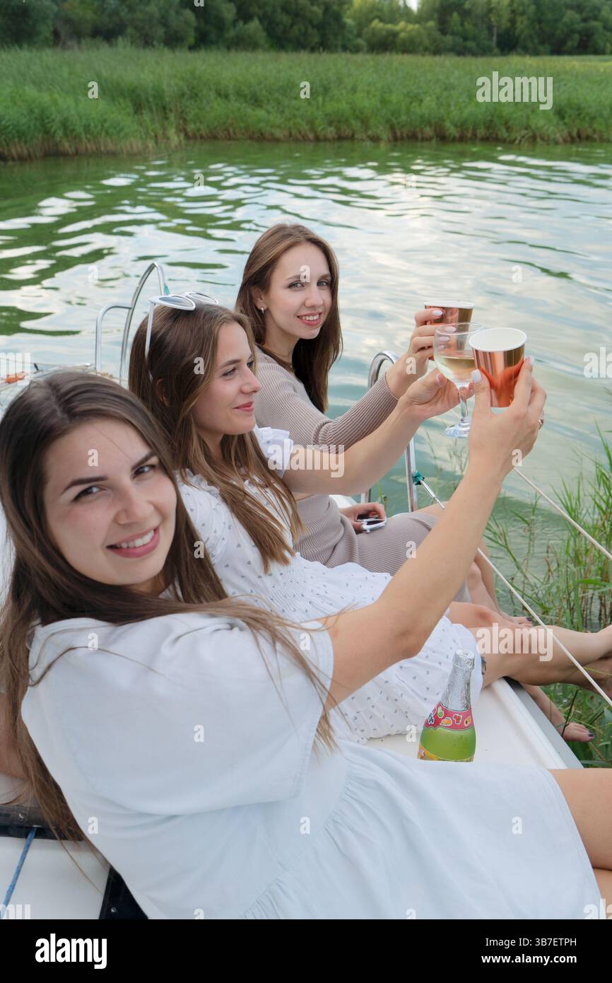 Celebrating a wonderful day on a sailboat Friends enjoying a delightful ...