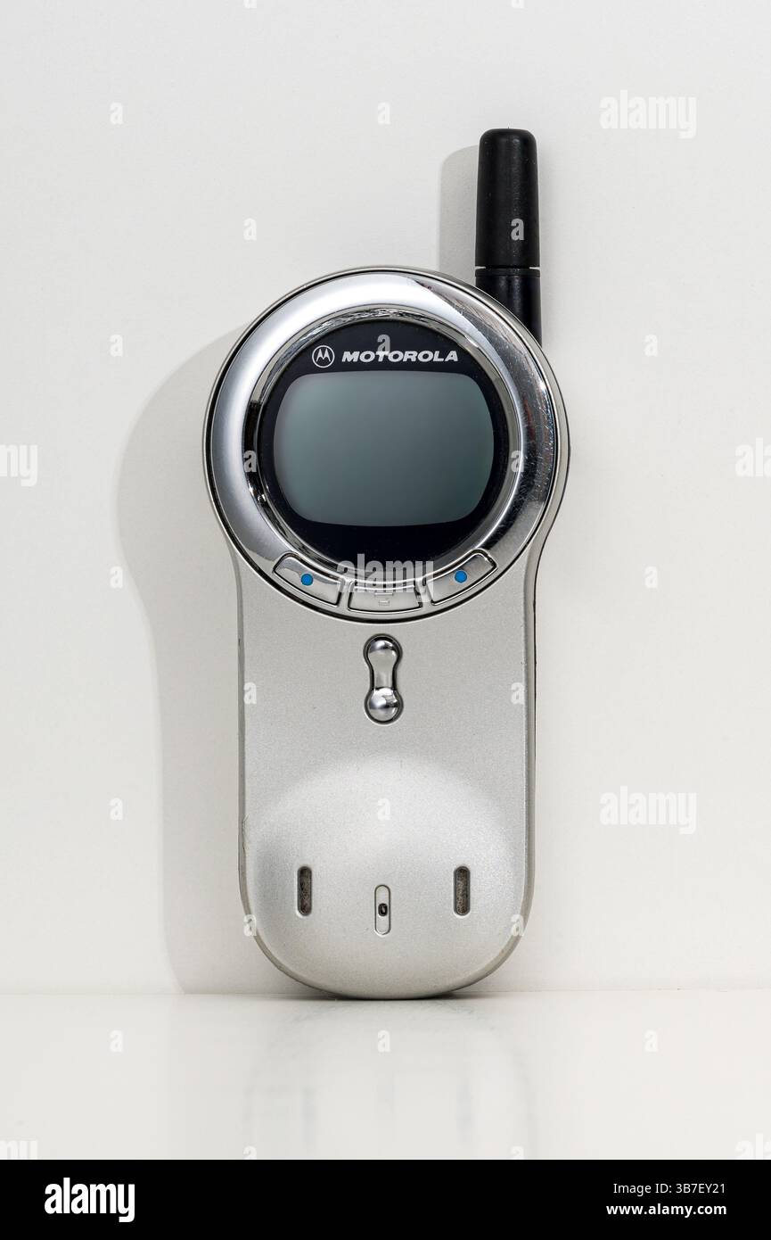 Motorola V70 vintage mobile phone with extended antenna standing on a ...