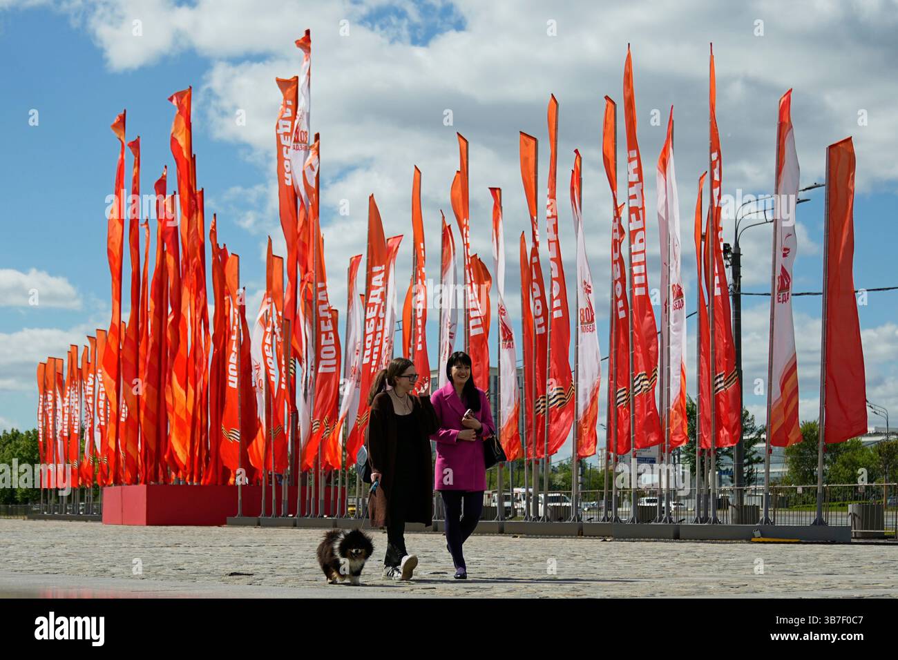 People walk along flags reading "Victory" in Russian, installed at the ...