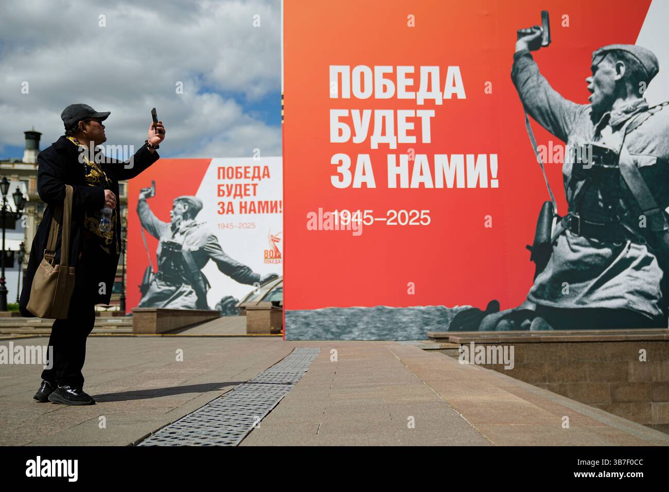 A man takes pictures of a poster showing the photograph Kombat (a ...