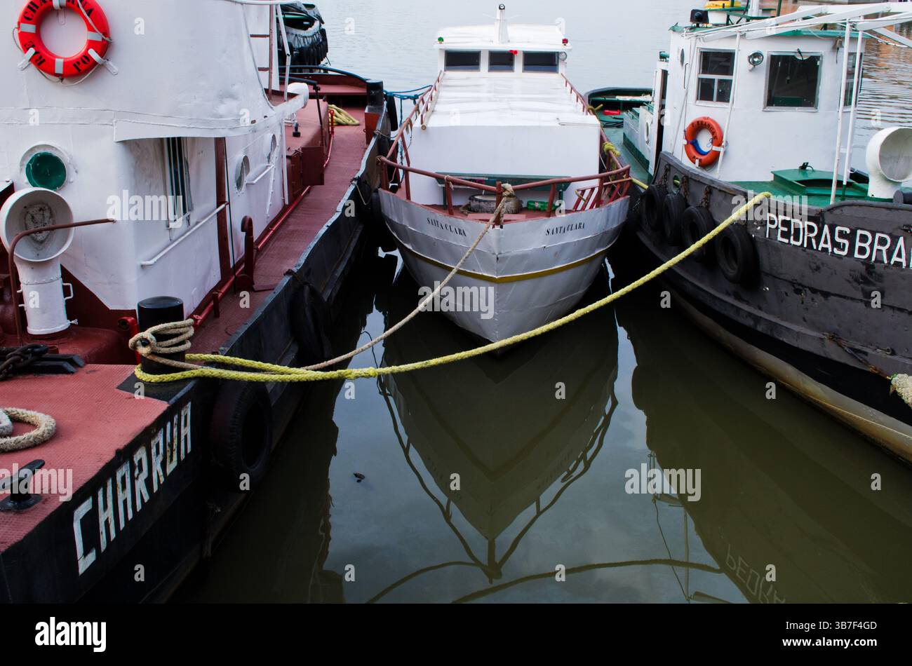 A small vessel between two larger attacked in the pier and leaving its ...
