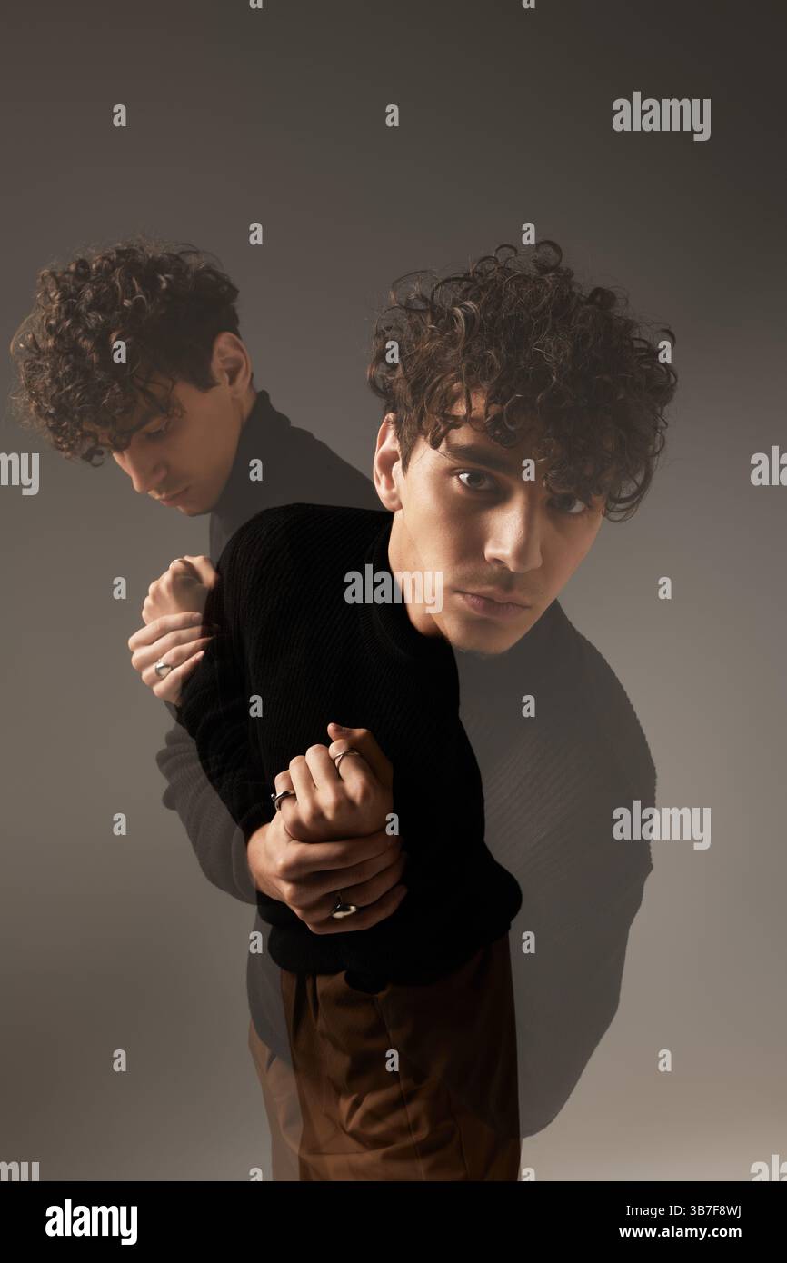 A handsome young man showcases his fashion sense with an engaging pose ...