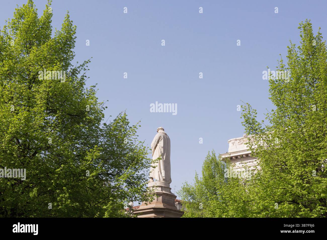 Rear view of the Leonardo da Vinci statue surrounded by lush green ...