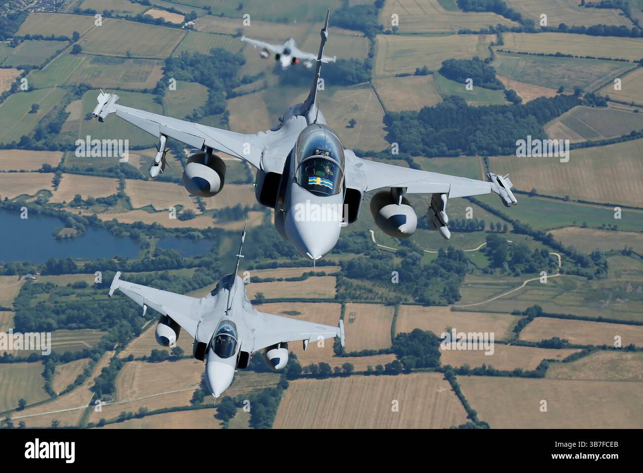The Swedish Air Force's Saab JAS 39C Gripen fighters fly in formation ...