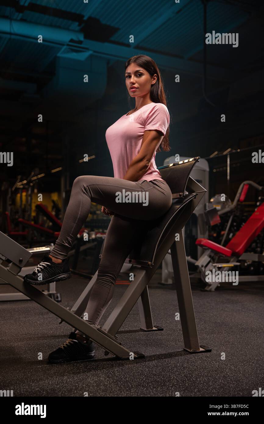 fitness model performs strength training on bench in gym showcasing her ...